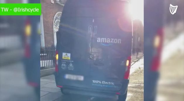 Amazon electric vehicle travelling through a cycling lane with parking ...