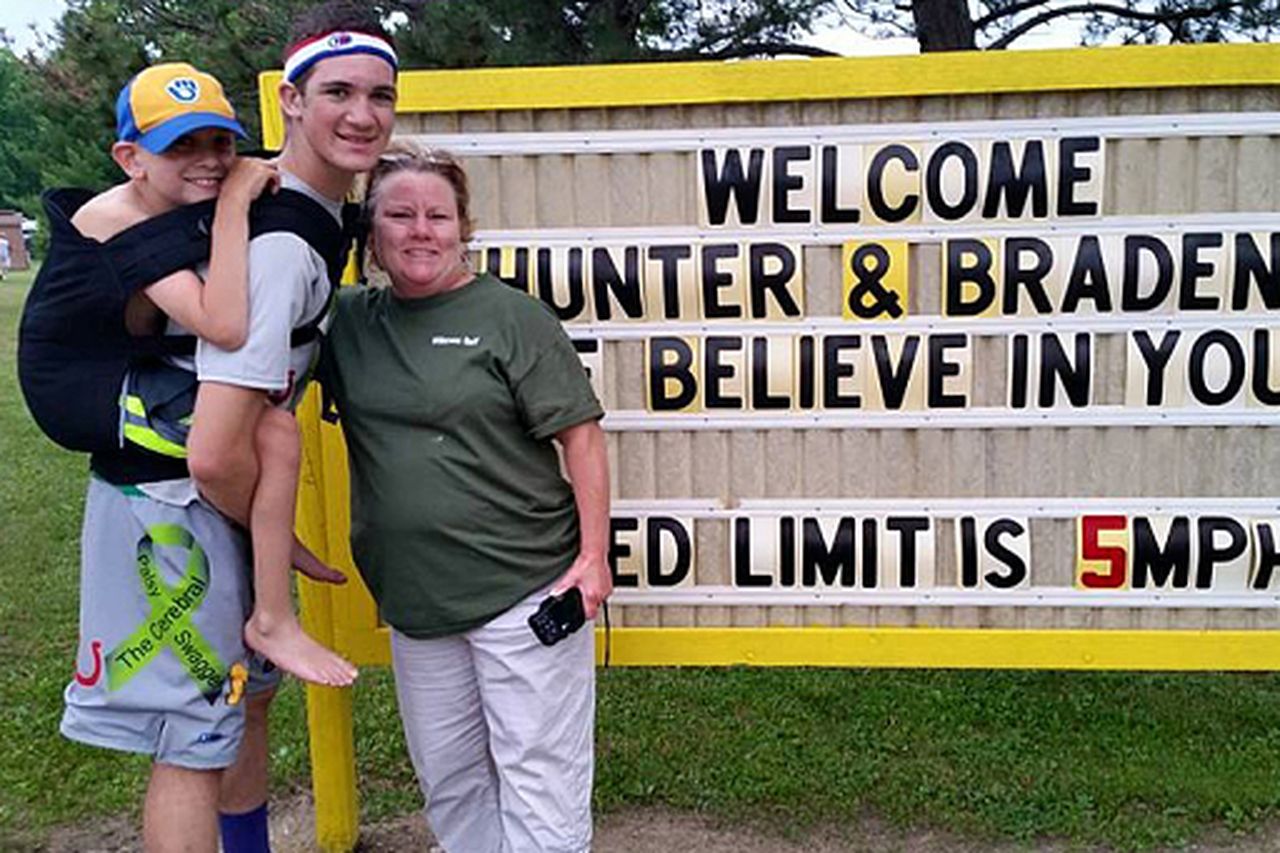 Teenager carries his disabled brother for 57 miles in charity walk for ...