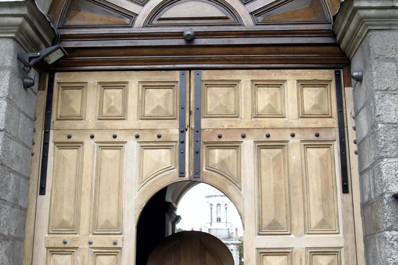 Iconic Trinity College wooden gates hang once again | Irish Independent