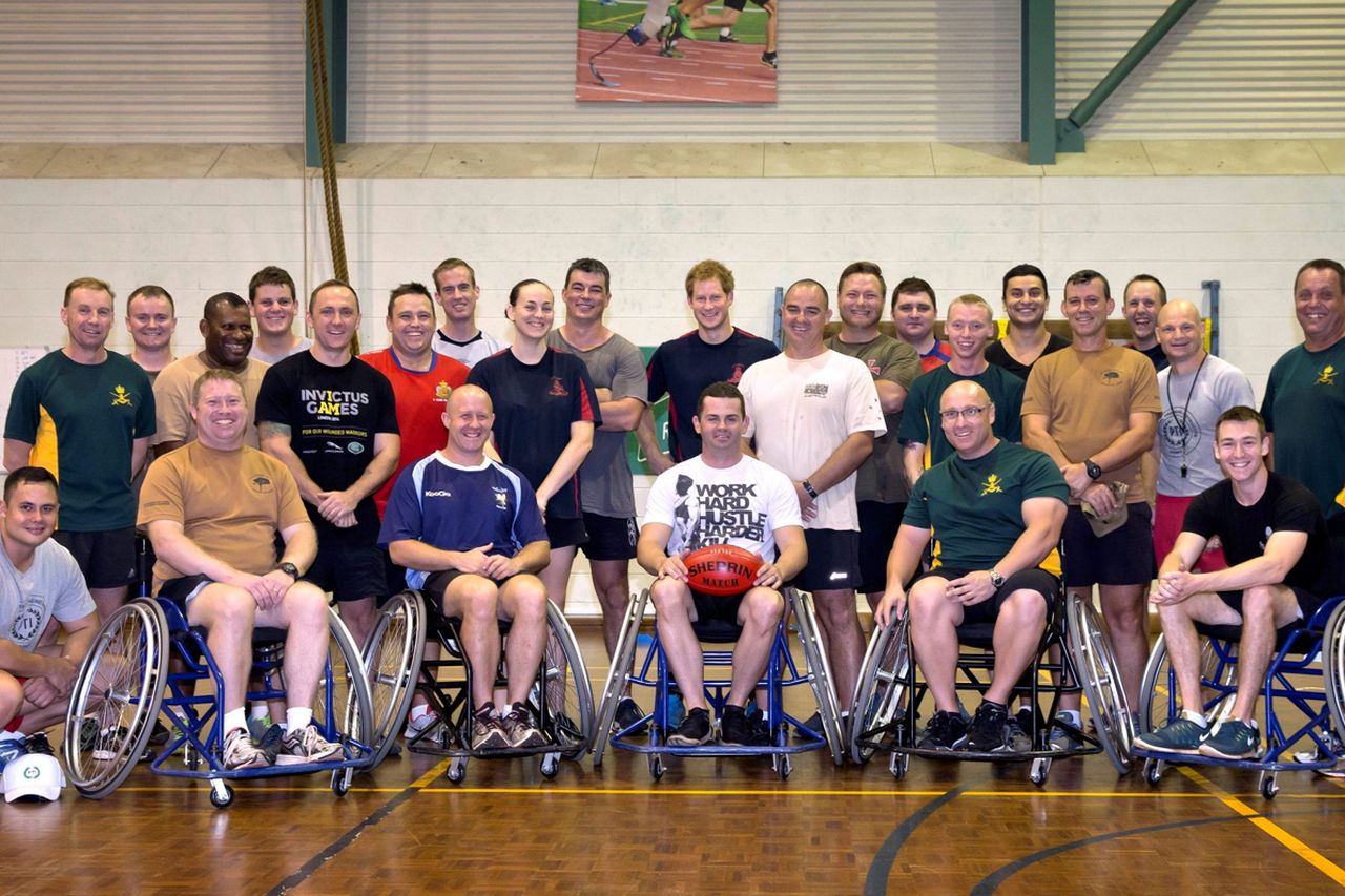 Prince Harry gets stuck into a game of wheelchair AFL at a Solider ...